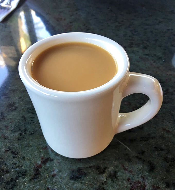 The humble white mug holds liquid ambition—bottomless coffee that's fueled Glendale's dreams for decades. No fancy latte art, just honest caffeine commitment.
