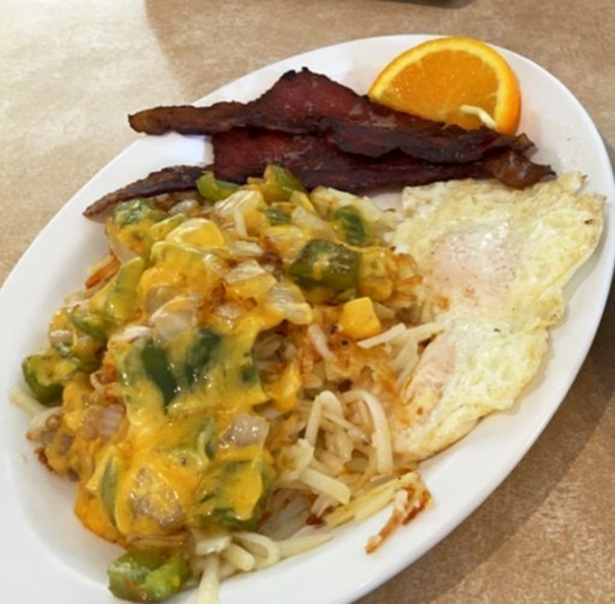 Western omelets should all aspire to this level of greatness—cheese cascading over perfectly diced peppers while bacon stands at attention like a delicious honor guard.