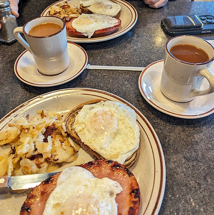 Morning glory on a plate! Eggs, home fries, and that essential cup of diner coffee – the breakfast trinity that's launched a thousand productive days.