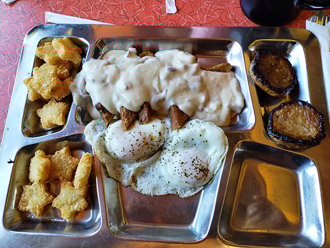Breakfast served on a metal tray isn't camping—it's diner perfection. Those eggs and gravy-smothered potatoes are ready for takeoff.