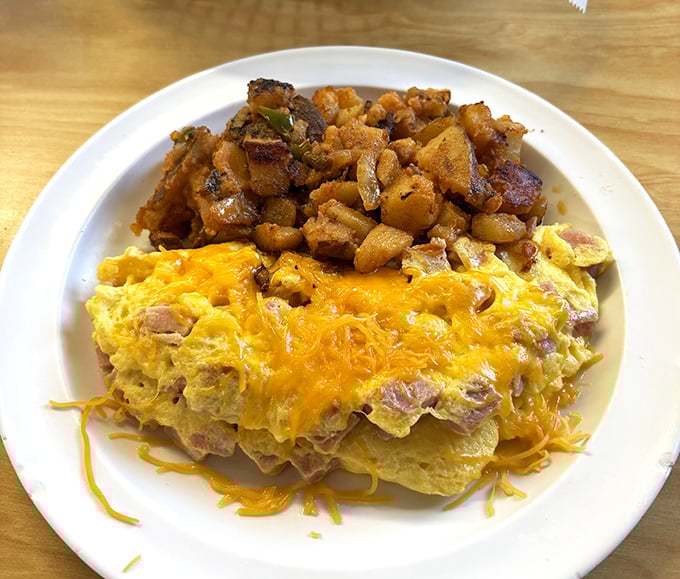 This ham and cheese omelet with home fries isn't just breakfast – it's edible therapy that costs less than a session with your therapist.