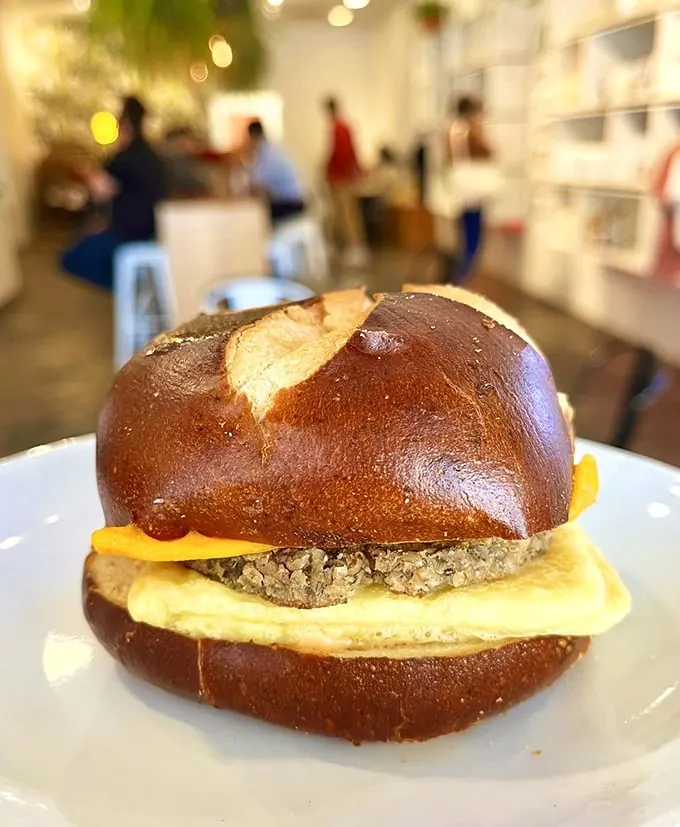 This isn't just a breakfast sandwich; it's morning salvation on a pretzel bun – the kind of protein-cheese-carb trifecta that makes waking up worthwhile.