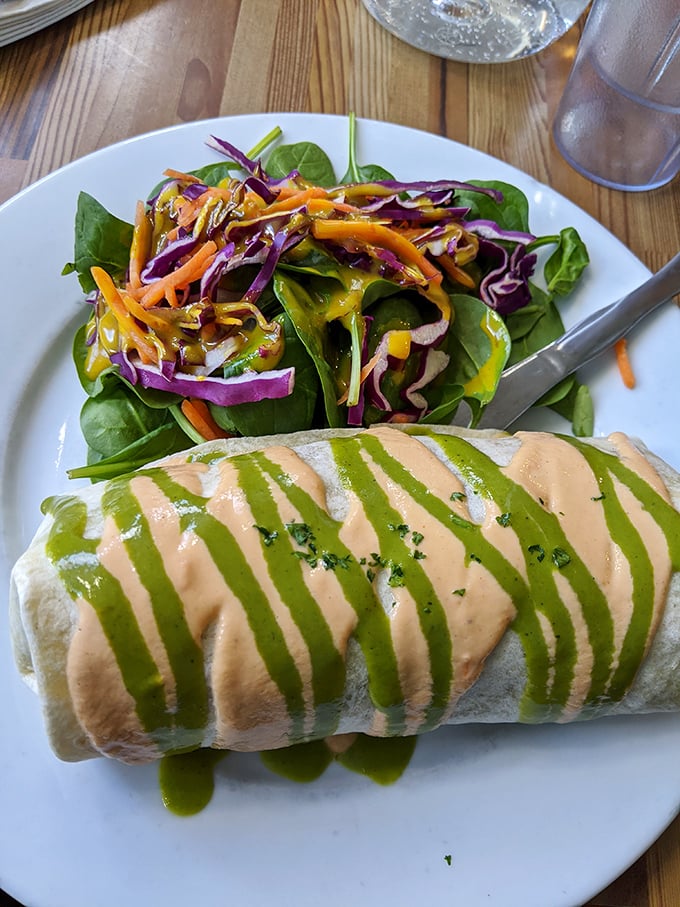 This isn't just a burrito—it's edible architecture. Layers of flavor wrapped in a tortilla and striped with sauces like a delicious abstract painting.