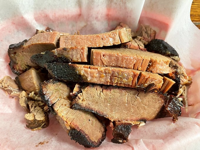 Brisket so tender it practically surrenders at the sight of your fork. That smoke ring isn't just pretty – it's a scientific miracle of flavor.