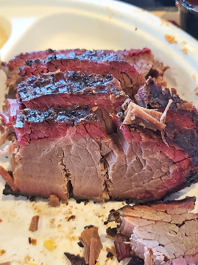 Behold the brisket in all its glory – that pink smoke ring is like nature's way of applauding proper BBQ technique.