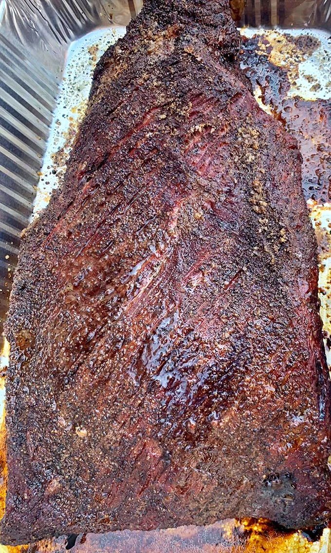 Behold the holy grail of barbecue – brisket with a bark so perfect it deserves its own security detail.