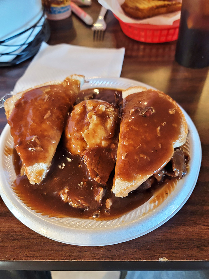 Behold the Manhattan of barbecue – bread islands piled with tender brisket, drowning happily in a sea of savory gravy. Your diet doesn't stand a chance.