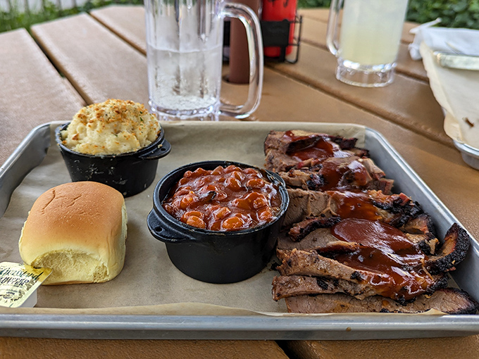 Behold the brisket plate in all its glory – tender slices of smoky perfection flanked by mac and cheese that's clearly been living its best life.