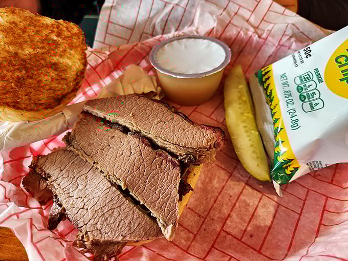 Brisket sliced thick enough to mean business but tender enough to surrender without a fight. That pickle isn't just garnish – it's necessary balance.