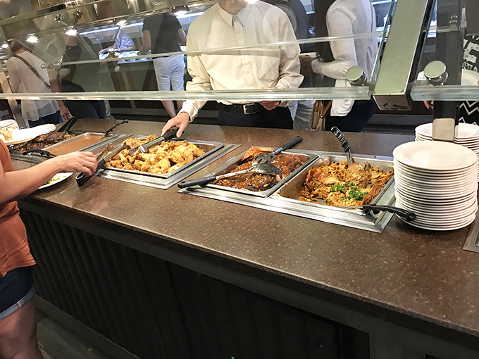 The buffet line—where decisions get tough and plates get full. Each tray holds another reason to loosen your belt before you even sit down.