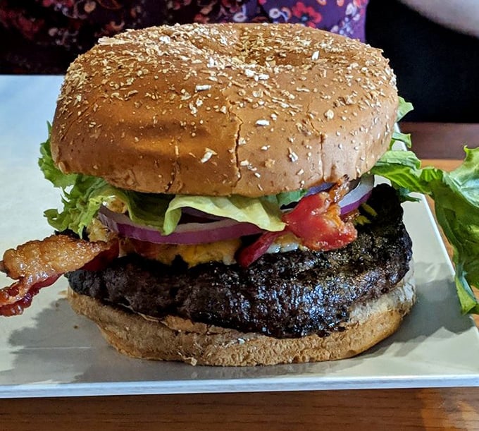 This isn't just a burger—it's a masterpiece of char-grilled perfection, where every layer from bun to bacon tells a delicious story.
