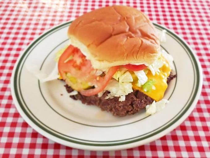 Behold the Rod Burger in all its glory—where melted cheese cascades over beef like a yellow waterfall of happiness on a perfectly toasted bun.