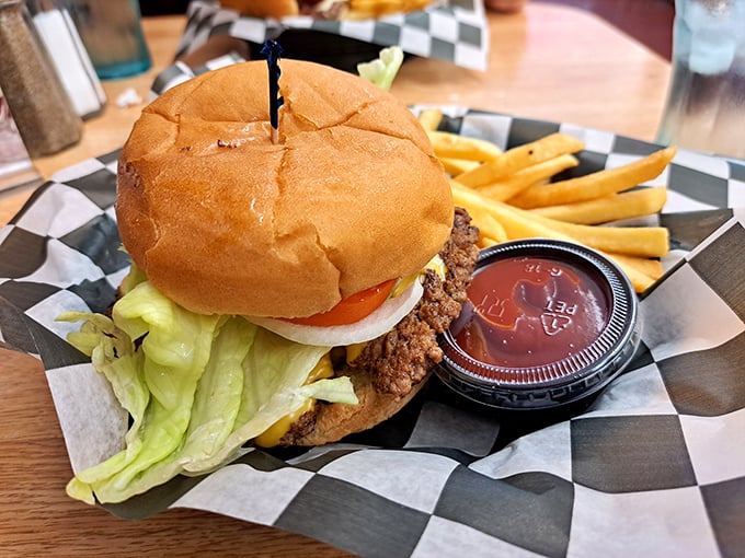 Behold the burger in its natural habitat—perfectly seared, properly dressed, and patiently waiting to make your day significantly better than it was five minutes ago.