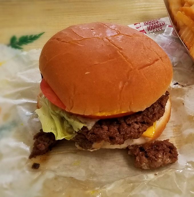 The star of the show in all its glory—a hand-formed patty on a pillowy bun that's worth every mile of the journey.