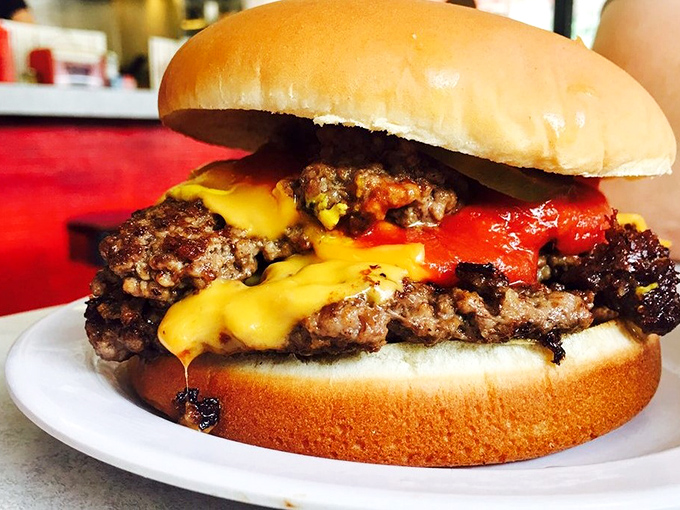 Not all heroes wear capes – some come on a soft bun with melted cheese cascading down hand-formed patties like a yellow waterfall of joy.