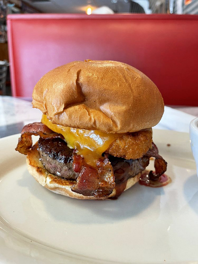 This isn't just a burger—it's a masterpiece of melted cheese cascading over perfectly seared beef, demanding both napkins and respect.