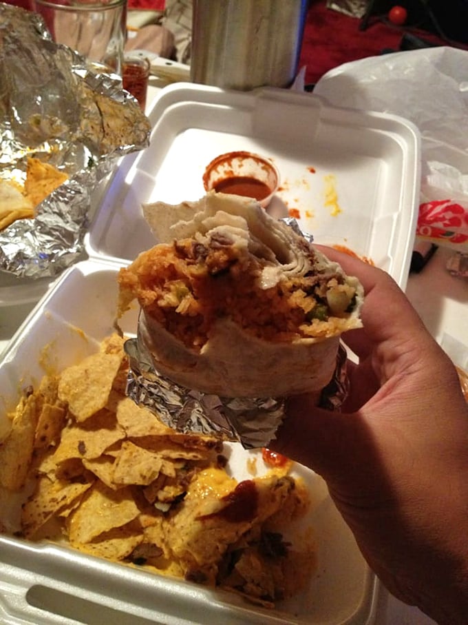 Behold the burrito in its natural habitat—halfway between the wrapper and someone's mouth. The proper way to experience this masterpiece.