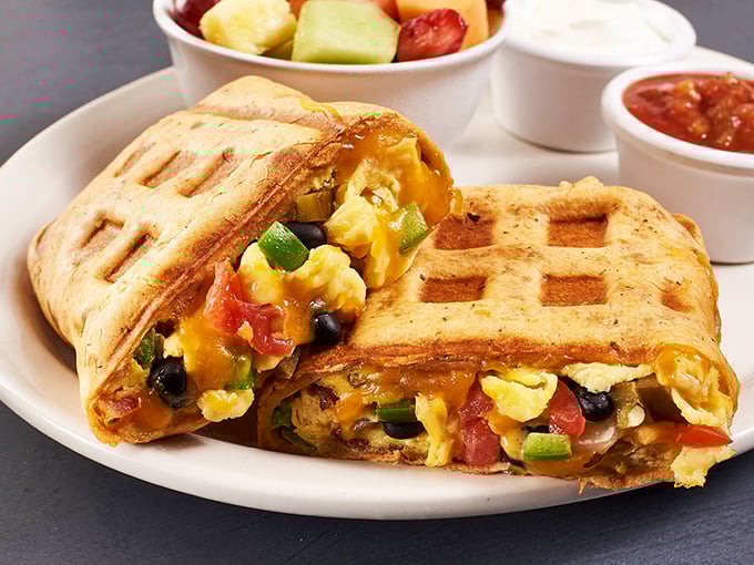 Breakfast innovation at its finest! This waffle sandwich stuffed with colorful veggies and eggs proves that diners aren't just about nostalgia—they're about delicious creativity.