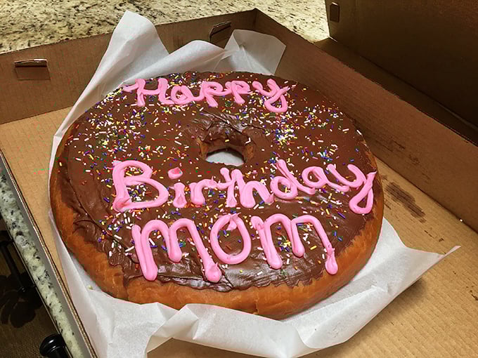 Someone's mom is having the birthday celebration she deserves—a giant chocolate-frosted donut that puts candles and cake to shame.