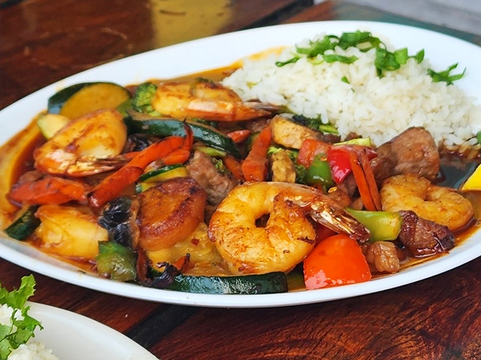 This isn't just dinner—it's a Caribbean vacation on a plate. Plump shrimp and colorful vegetables dance in sauce alongside perfectly cooked rice.