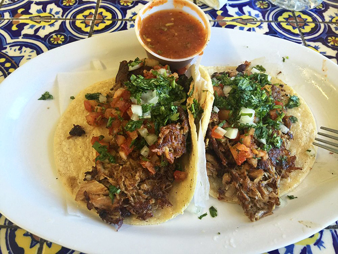 These carnitas tacos aren't just food—they're an event. Perfectly crisped pork crowned with fresh cilantro and pico de gallo, waiting for that squeeze of lime.