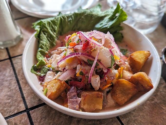 Ceviche that dances with freshness – tender fish mingling with crisp vegetables and citrus in a bowl that might as well be labeled "summer vacation."