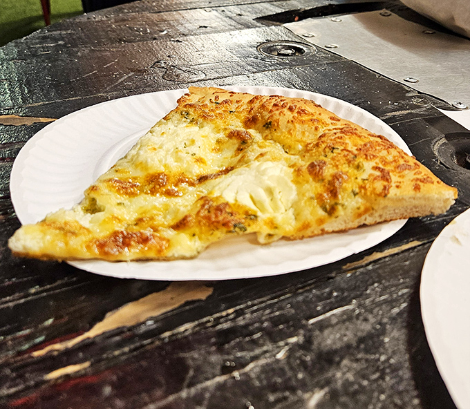 Behold the cheese pull that launched a thousand road trips. This isn't just pizza—it's Cleveland's edible ambassador to your taste buds.