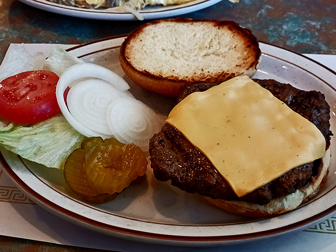 Behold the star of the show—a perfectly proportioned cheeseburger that doesn't need Instagram filters or fancy toppings to make your mouth water.