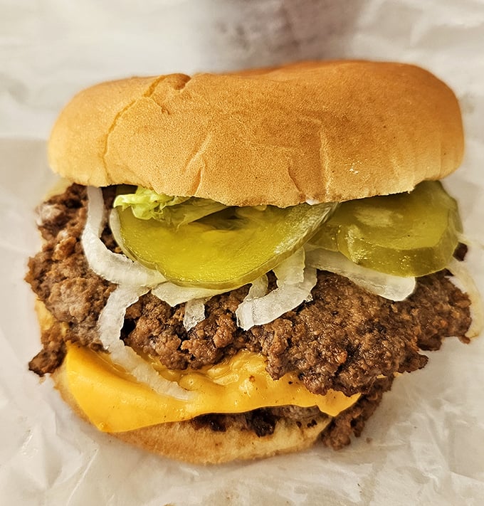 This isn't just a cheeseburger—it's edible nostalgia. The melty American cheese cascading over hand-formed beef with those perfect pickle slices is what fast food chains try desperately to imitate.