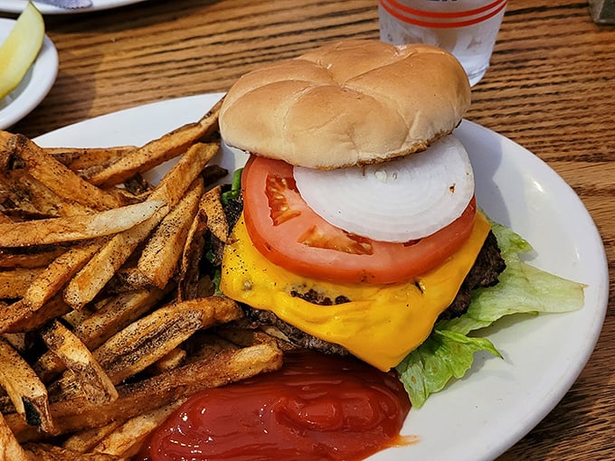 This isn't just a cheeseburger—it's architecture. The foundation is beef, the infrastructure is cheese, and those fries are the landscaping. 