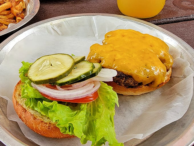 This isn't just a cheeseburger—it's a masterpiece of melty perfection atop a hand-formed patty, with fresh veggies standing by for that essential textural contrast.
