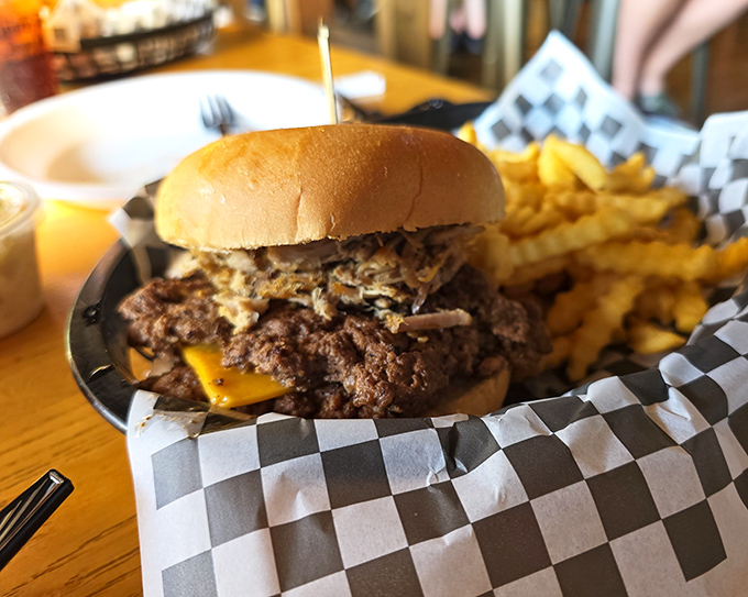 Behold the burger that launched a thousand road trips—your arteries just filed a formal complaint.