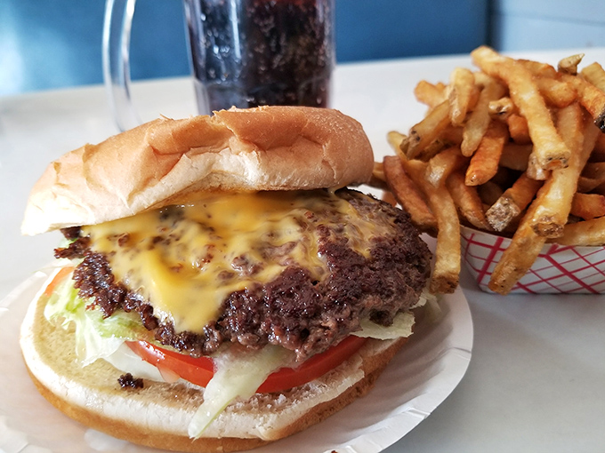 The cheeseburger at Porky's doesn't need fancy aioli or artisanal buns to impress—just a perfectly seasoned patty, melty cheese, and fresh toppings on a pillowy bun.