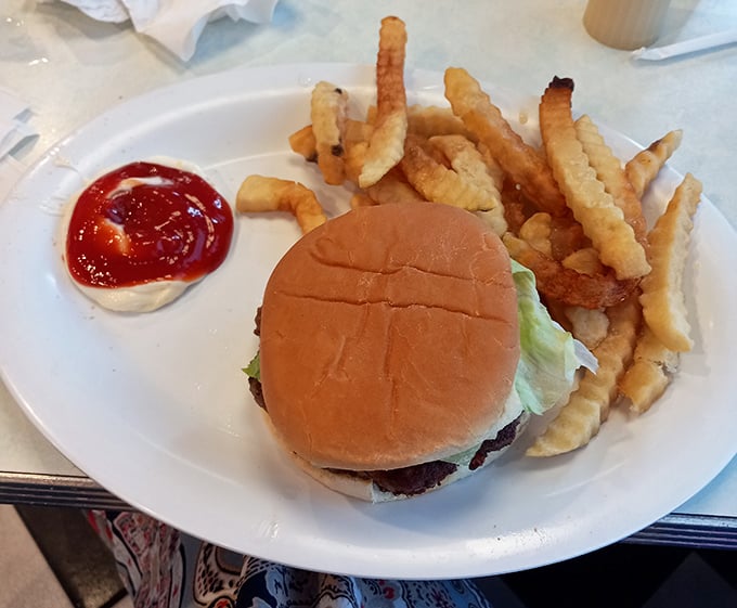 This isn't just a burger—it's edible nostalgia on a bun, served with crinkle-cut fries that crunch like childhood memories.