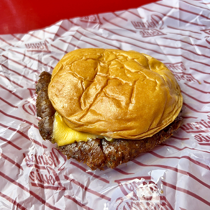 This isn't just a cheeseburger—it's edible architecture where every layer contributes to a symphony of flavors that makes your taste buds dance.