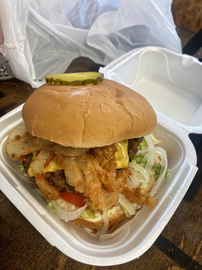 Crispy onion strings cascade over melted cheese like a waterfall of flavor. This isn't just a sandwich; it's architecture.