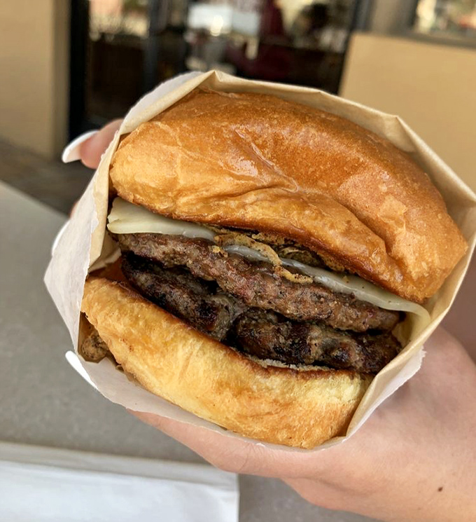 Behold the burger in its natural habitat – perfectly charred, gloriously juicy, and nestled in a toasted bun. Poetry between bread.