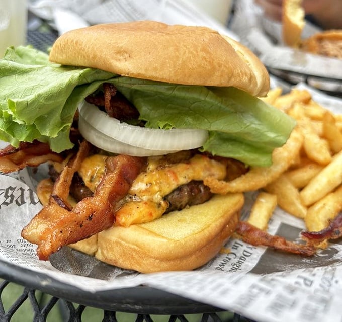 Behold the star of the show! This burger doesn't need fancy filters – just melty cheese cascading over a char-grilled patty with fresh toppings and golden fries.