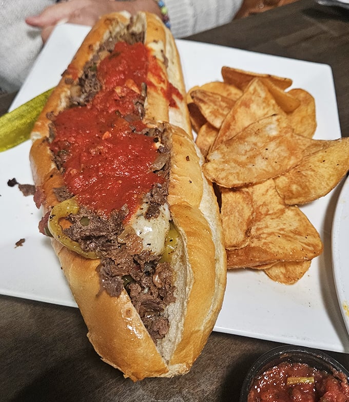 Behold, the star of the show! This marinara-topped cheesesteak isn't just a sandwich—it's a Pennsylvania passion project served with perfectly golden chips.
