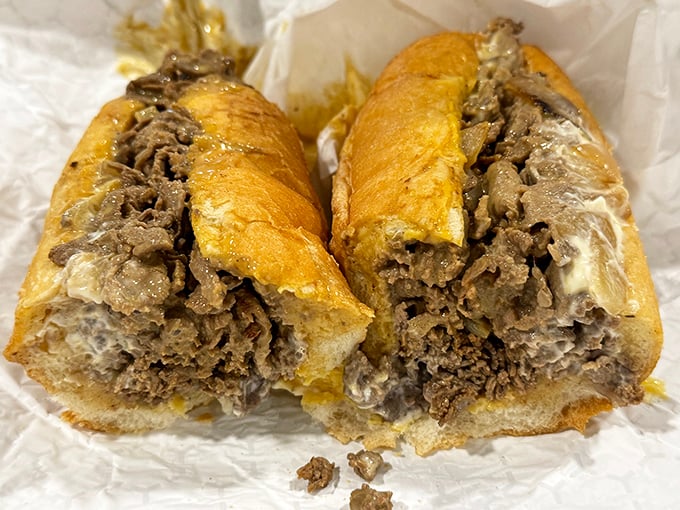 Behold the cheesesteak in its natural glory—thinly sliced ribeye embracing melted cheese like they've been waiting their whole lives for this moment.