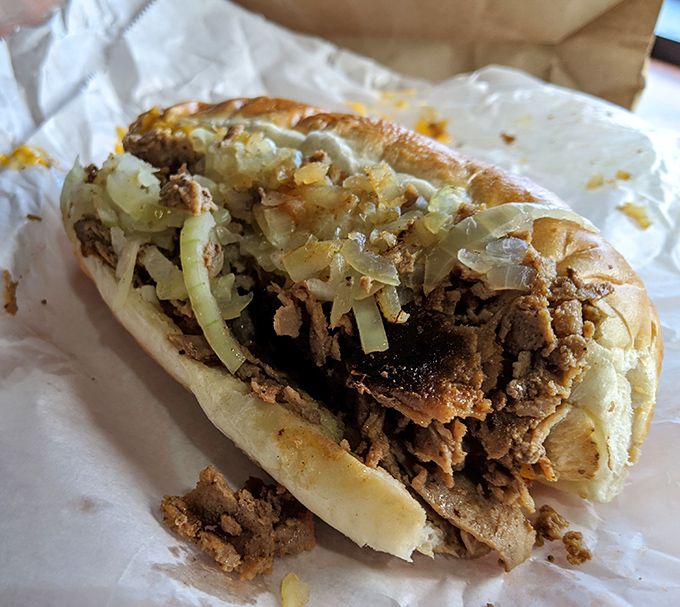 Behold the star of the show – thinly sliced ribeye and caramelized onions nestled in a perfect roll. This isn't just a sandwich; it's an Allentown institution on wax paper.