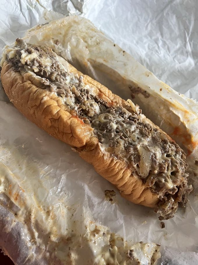 Behold the star of the show – ribbons of tender ribeye nestled in that perfect Amoroso roll, cheese melted into every nook and cranny.