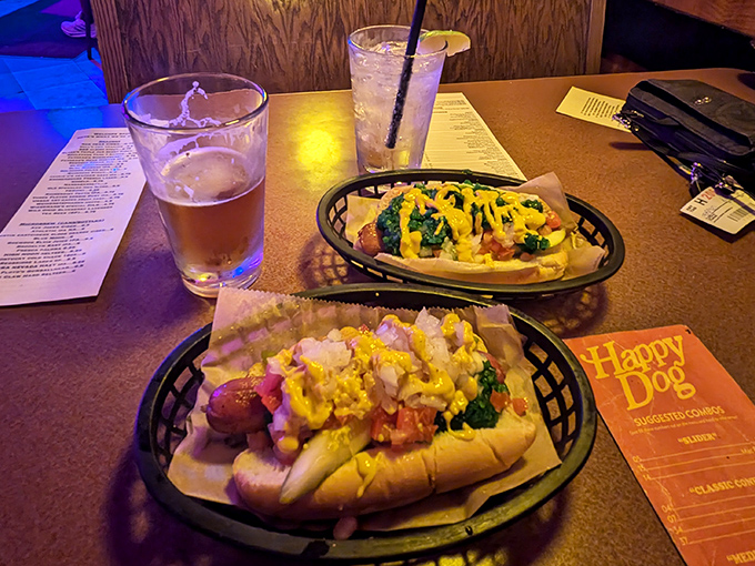 Hot dog heaven on a plate! These loaded beauties showcase why choice is beautiful. Yellow mustard cascades over toppings that make each bite a flavor adventure.