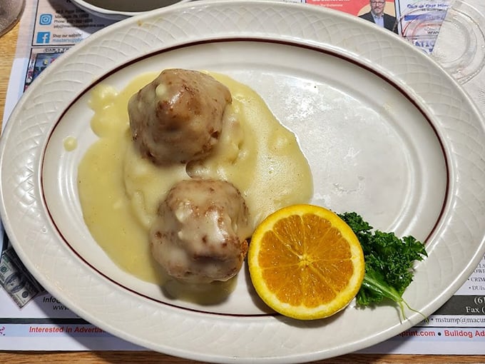 These chicken croquettes aren't just food; they're edible poetry—golden-brown spheres of seasoned perfection swimming in gravy that would make your grandmother weep with joy.