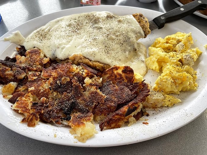 Behold the star attraction: chicken fried steak smothered in pepper-flecked gravy with a side of scrambled eggs. Breakfast nirvana achieved.