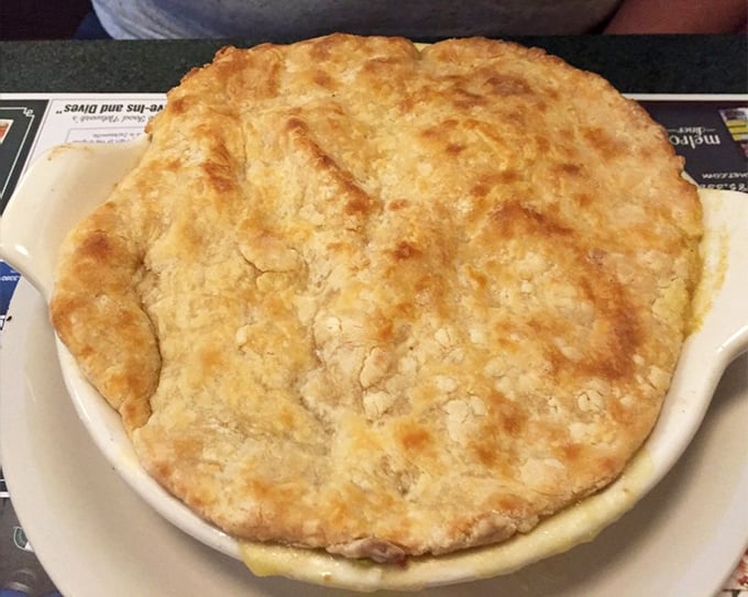 Golden, flaky crust puffed up like it's showing off – this chicken pot pie doesn't just satisfy hunger, it soothes the soul.
