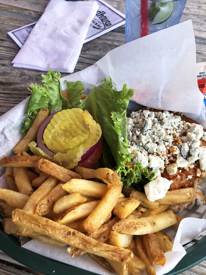 This isn't just a sandwich; it's edible architecture—crisp lettuce, juicy tomato, and what appears to be feta crumbles creating the perfect foundation for happiness.