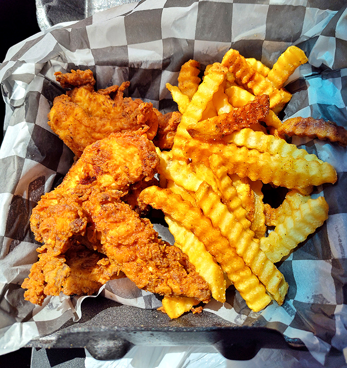 Golden-brown chicken tenders nestled against crinkle-cut fries—a combination so perfect it should have its own national holiday.