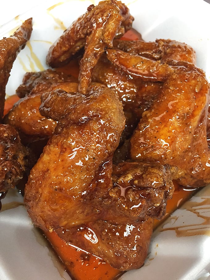 These glistening, sauce-drenched wings aren't just food—they're a religious experience. Each one perfectly crisp outside, juicy inside, like chicken wing nirvana.