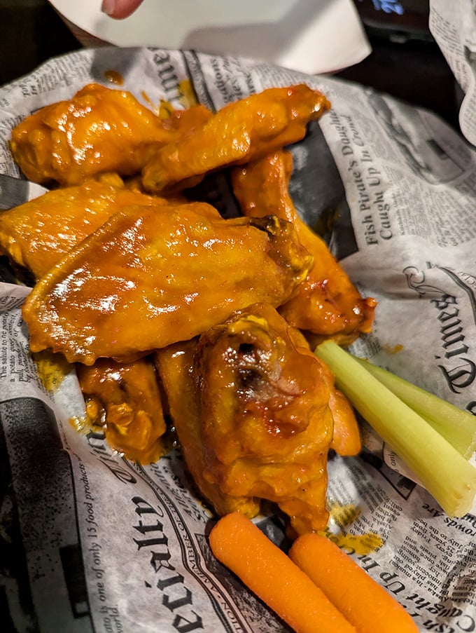These wings aren't just orange—they're practically glowing with flavor potential. Served with celery sticks for that token nod to vegetable responsibility.
